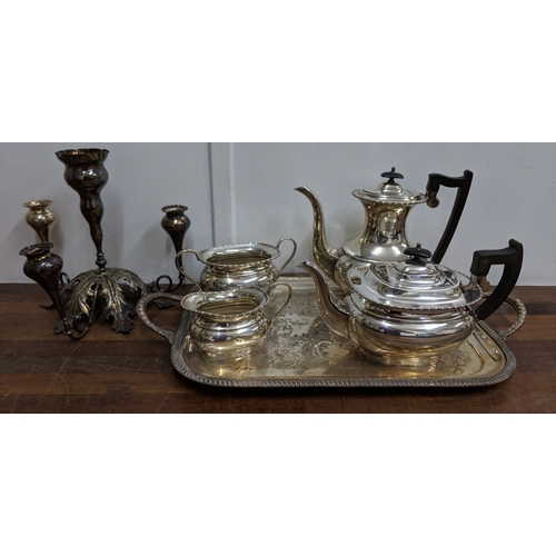 A four-piece silver plated tea set and a twin handled tray and a ...