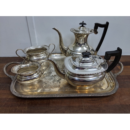 A four-piece silver plated tea set and a twin handled tray and a ...