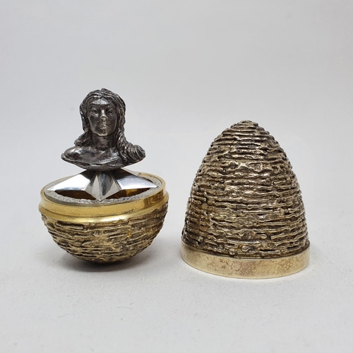 A silver gilt surprise egg in teh manne of Stuart Devlin, with textured ...
