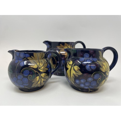 A graduated set of three jugs, decorated grapes and vines, and assorted ...