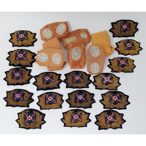 A group of new old stock Union Castle cap badges