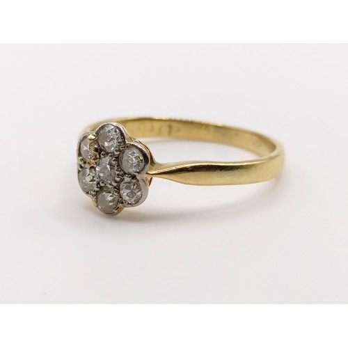 An 18ct gold and diamond flower head ring, ring size K 1/2, 2.0 g (all in)