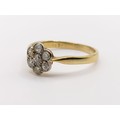 An 18ct gold and diamond flower head ring, ring size K 1/2, 2.0 g (all in)