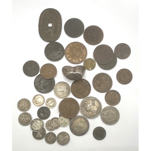 A small Chinese sycee silver ingot and assorted coins