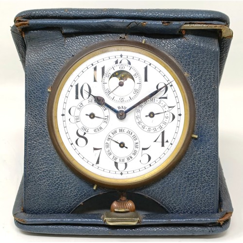 A silver plated travelling clock, with subsidiary month, day dial moon ...