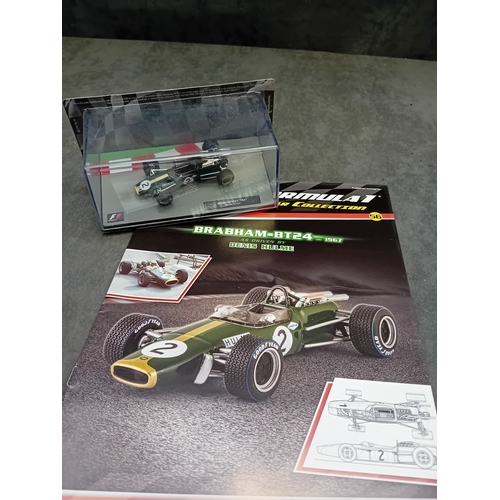A collection of five die-cast metal and plastic scale model Formula 1 ...