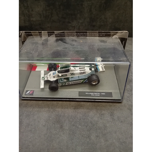 A collection of five die-cast metal and plastic scale model Formula 1 ...