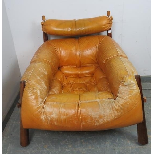 A vintage mid century lounge chair by Percival Lafer model MP 81 upholstered in distressed button