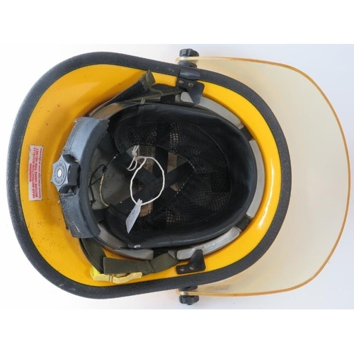 A 1980s British Cairns Metro fire helmet with visor, bearing Kent Fire ...