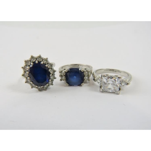 Two ‘Tru Diamonds’ synthetic oval sapphire & white stone rings; and ...