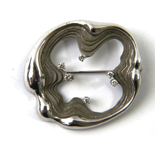 A Modernist diamond and precious white metal brooch of abstract ...