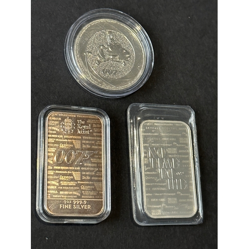 Two silver James Bond bullion bars and one fine silver coin all ...