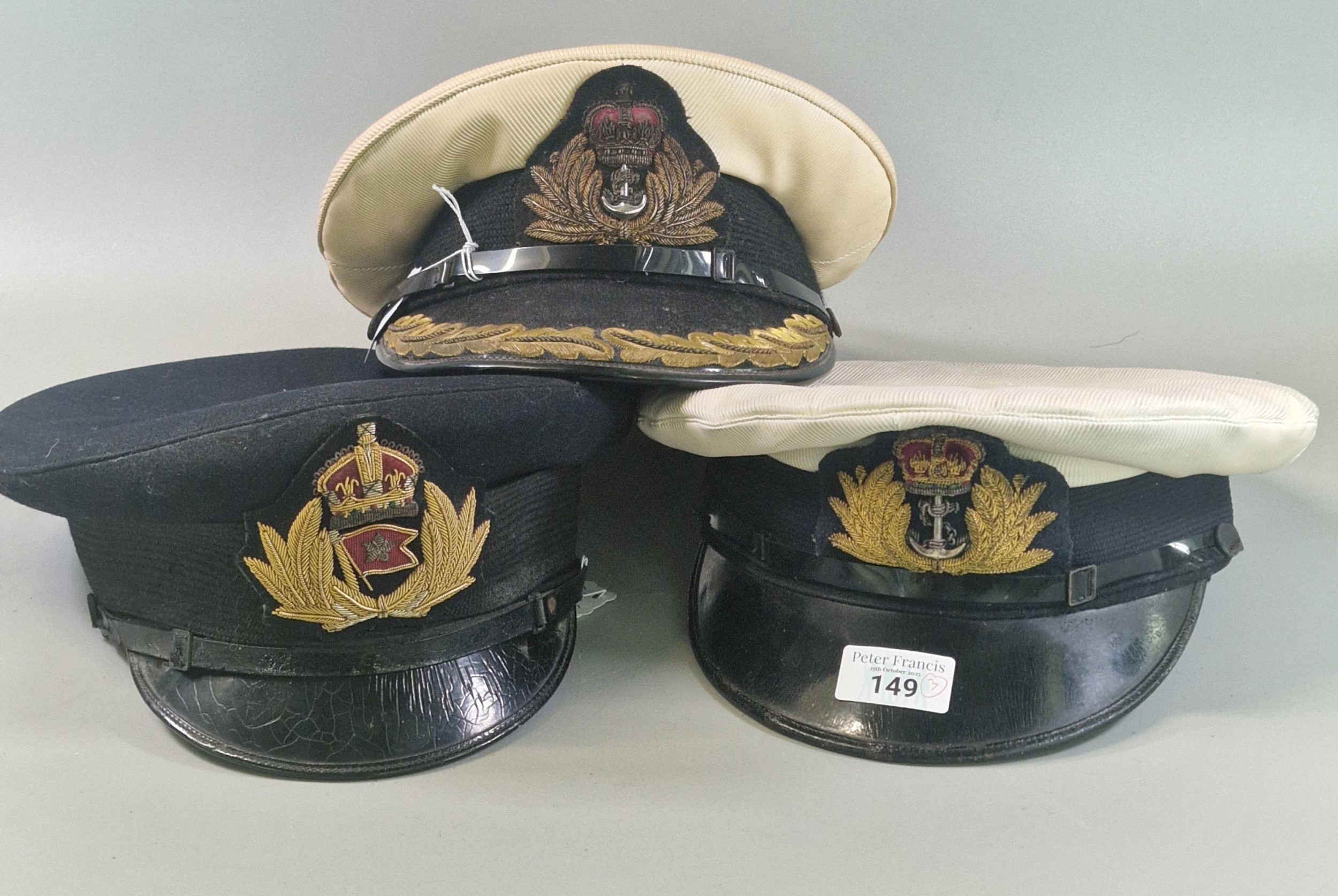 Collection of three naval caps, comprising a Royal Navy Captain ...