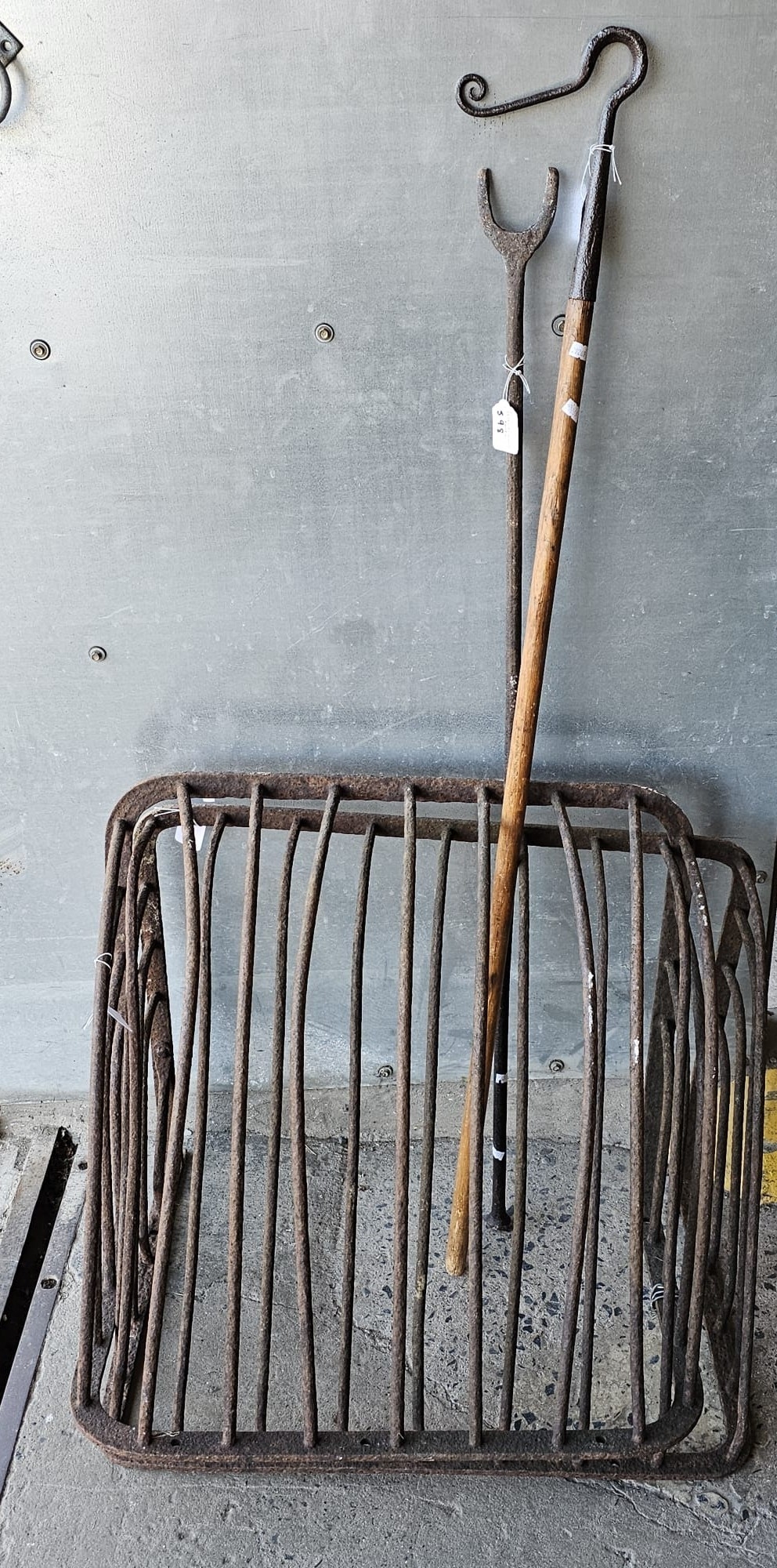 Two wrought iron stable mangers, together with an iron headed Shepherd ...