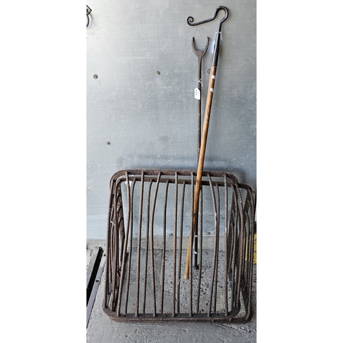 Two wrought iron stable mangers, together with an iron headed Shepherd ...