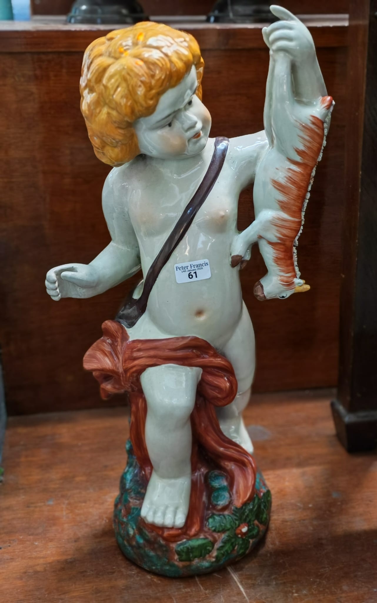 Staffordshire style porcelain figurine of a cherub holding a baby calf ...