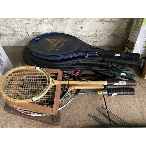 A quantity of tennis rackets and vintage badminton rackets