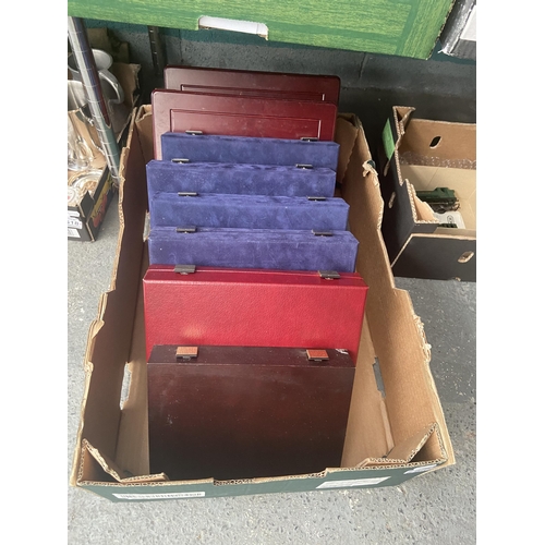 Box containing empty coin presentation boxes