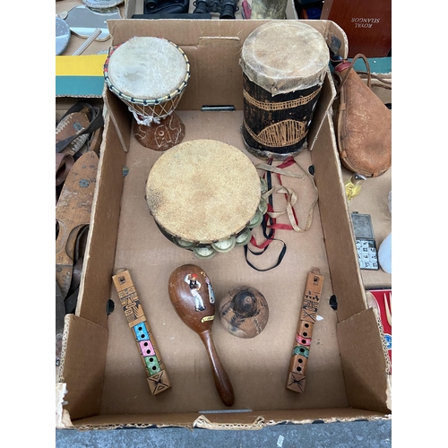 Box containing assorted handmade musical instruments