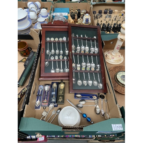 Box containing collector's spoons in display cases