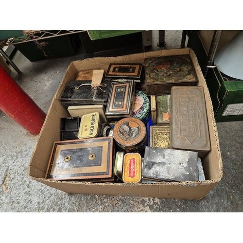 Box containing assorted vintage tins