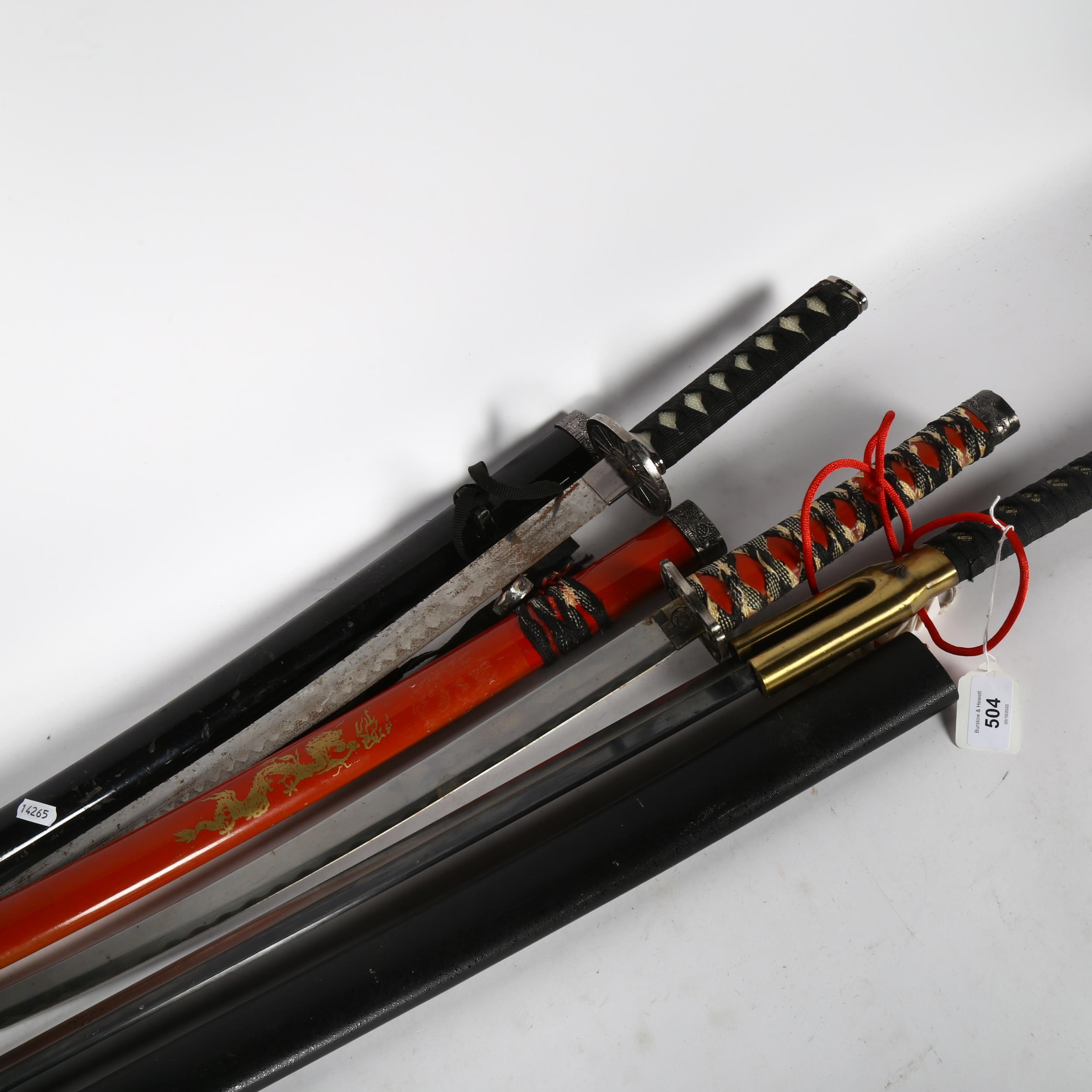 A reproduction set of 3 graduated Samurai swords, to include a ...
