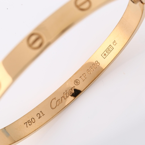 CARTIER - a modern 18ct gold 'LOVE' bangle, with screwhead motifs ...