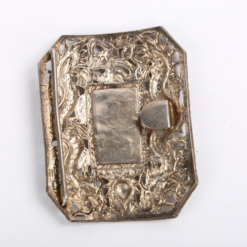 A Chinese silver dragon belt buckle, with central character marks and ...