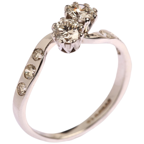 An 18ct white gold two stone diamond crossover ring, maker EF, London ...