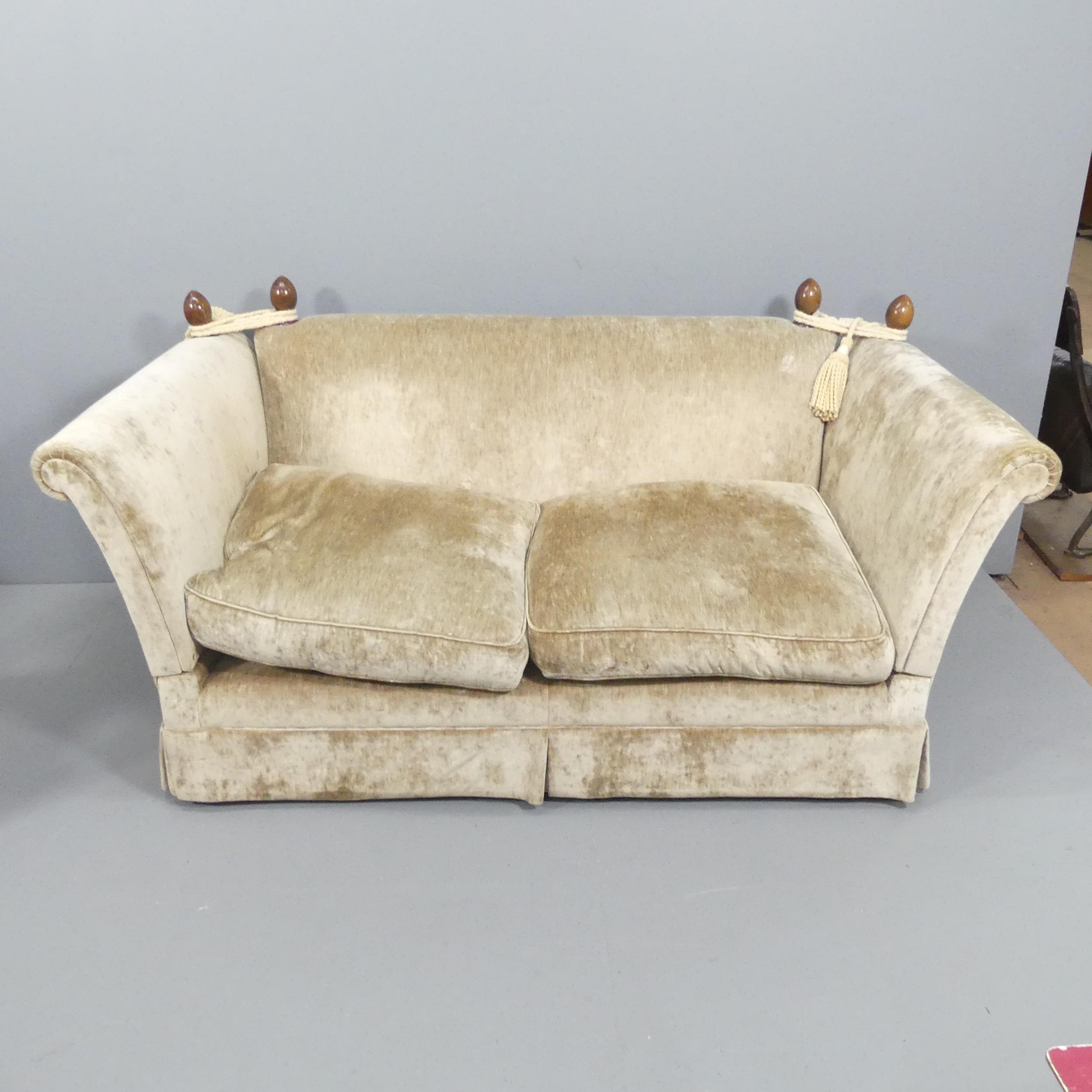 A contemporary velvet upholstered two-seater Knole style sofa with two ...