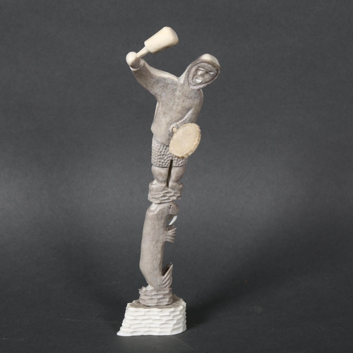 An Inuit bone carving figure, a Walrus mounted by figure, by Simo ...
