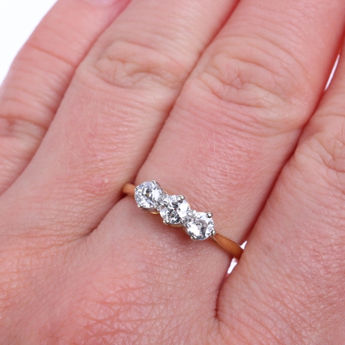 A three stone diamond ring, claw set with old European-cut diamonds ...