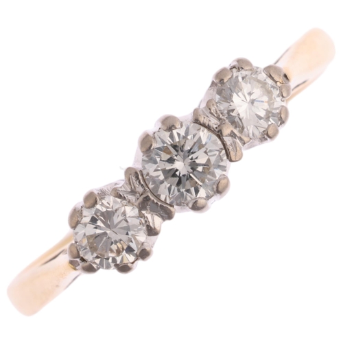 An 18ct gold three stone diamond ring, maker FWA, London 1973, set with ...