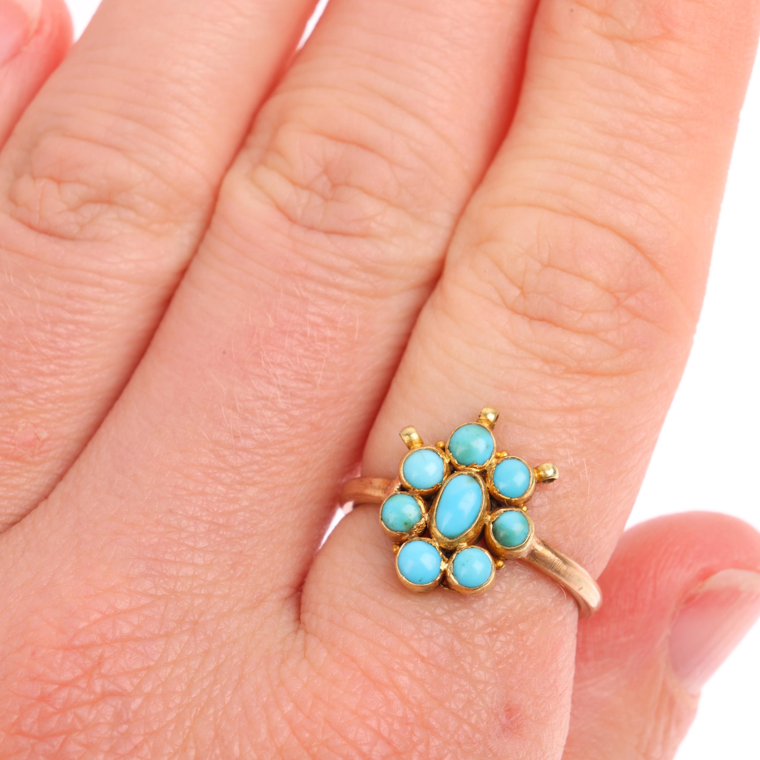 An Antique turquoise cluster ring, set with round and oval cabochon ...
