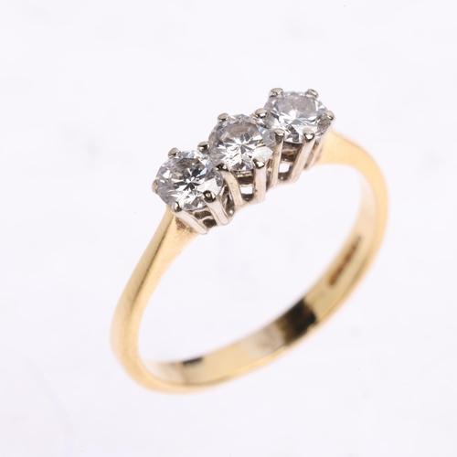 An 18ct gold three stone diamond ring, maker HWT, claw set with modern ...