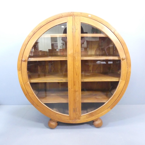 A pine Art Deco style circular bookcase, with four fixed shelves behind ...