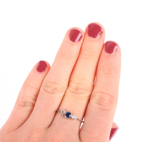 A platinum (tested) three stone sapphire and diamond ring, rub-over set ...