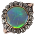 An Antique 18ct gold opal and diamond cluster ring, rub-over set with ...