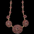 HUGO GRUN - a Danish silver-gilt Bohemian garnet collar necklace, set ...