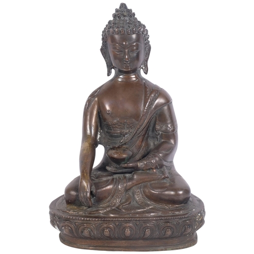 Oriental embossed bronze figure of a seated Buddha, 25.5cm