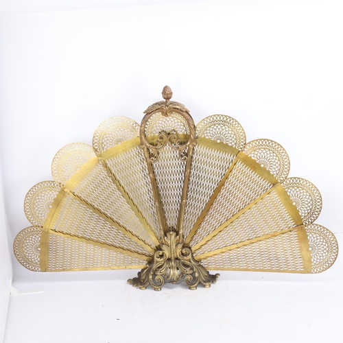 A Victorian brass peacock fan fire screen, on heavy cast-brass acanthus ...