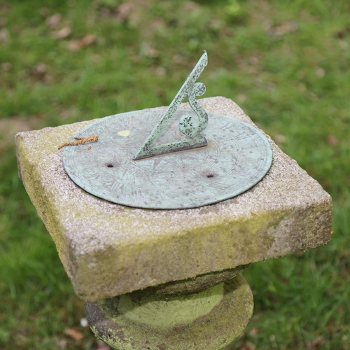 A weathered stone and copper sundial, height 84cm, width 30cm