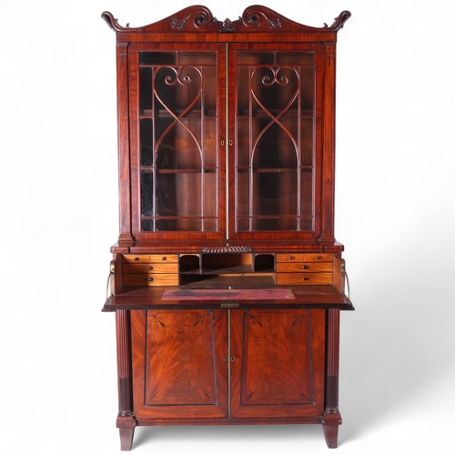 A Regency mahogany secretaire library bookcase, with scroll carved ...