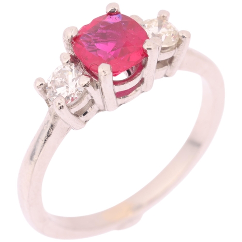 A platinum three stone ruby and diamond ring, maker JC, claw set with 0 ...
