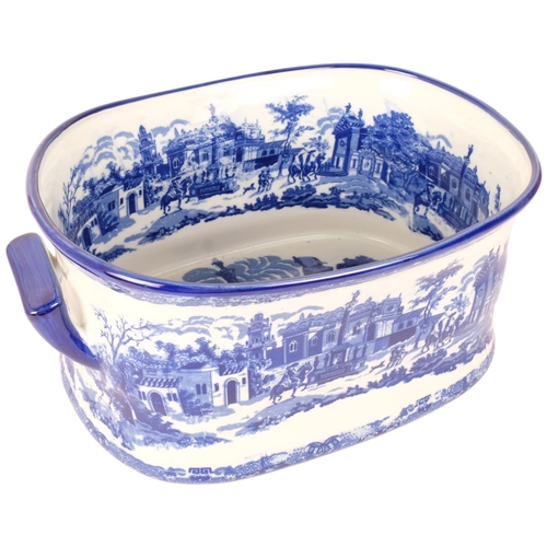 A reproduction blue and white pottery foot bath, L42cm