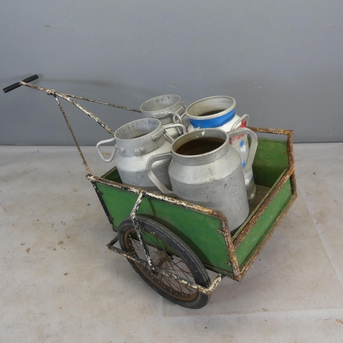 A vintage French milkman's hand cart containing four galvanised milk ...