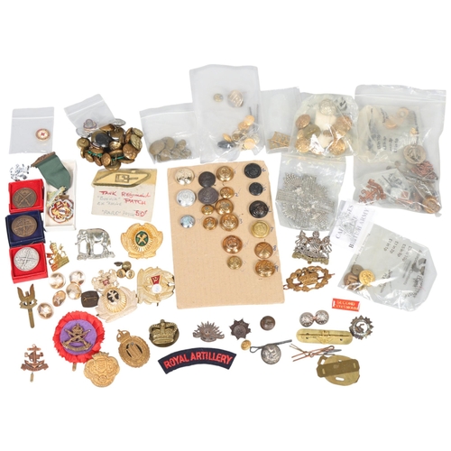 A collection of military badges and buttons, including cloth badges and ...