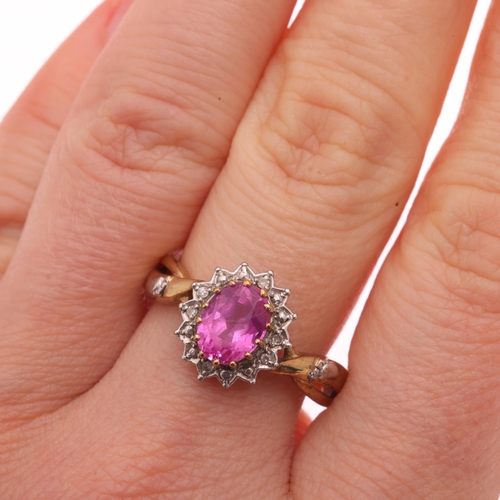 A 9ct gold pink sapphire and diamond cluster ring, claw set with oval ...