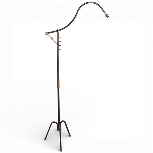 A vintage French blackened iron floor lamp with pivot arm and brass ...