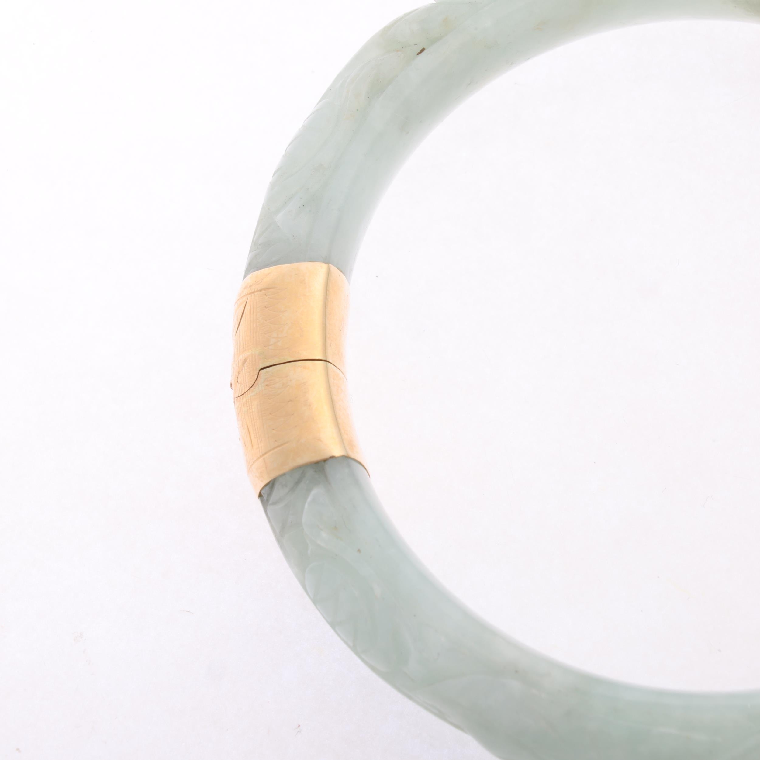 A 14ct gold mounted jade hinged bangle, QVC, carved and polished dragon ...